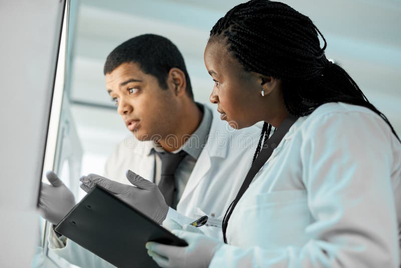Coming Closer To the Truth. Two Scientists Working Together in a Lab ... Coming Closer To the Truth. Two Scientists Working Together in a Lab ...