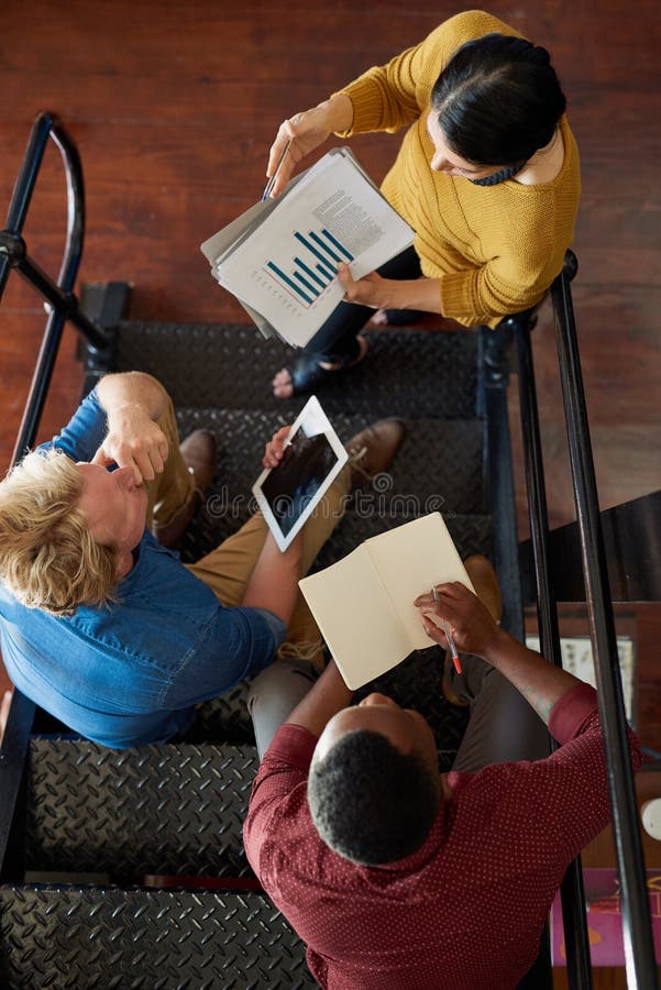 Coming Up with Ideas To Push Up the Numbers. a Group of Creative ...