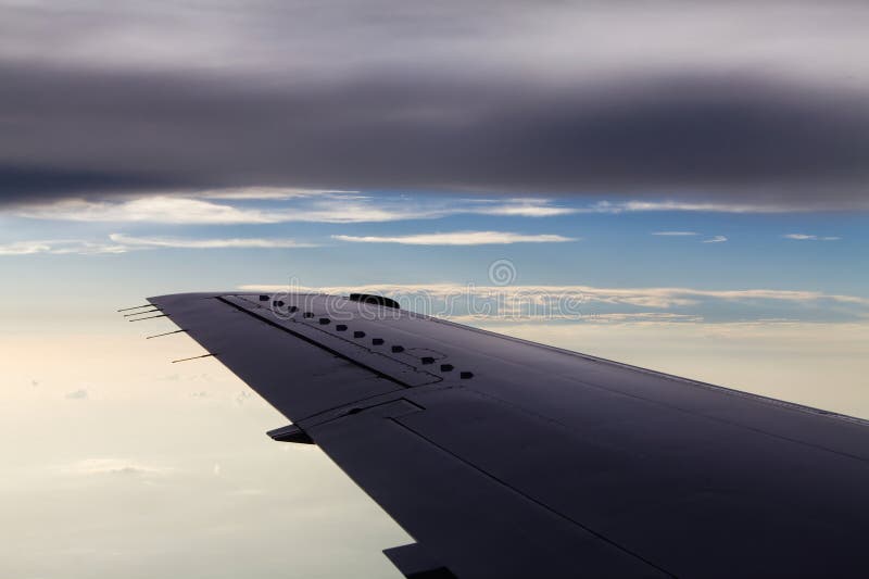 Commercial Aircraft Wing in Flight between Two Layers of Clouds Stock Image - Image of aircraft ...