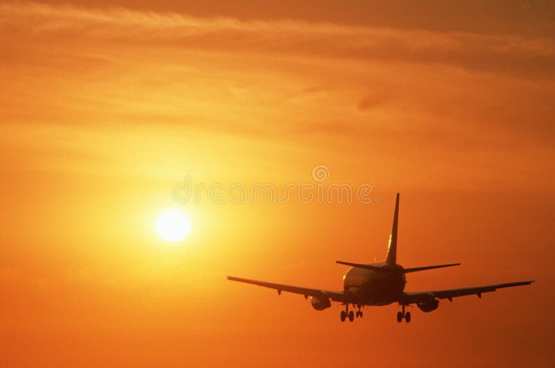 Commercial Jet Flying into Sunset Stock Photo - Image of engine ...