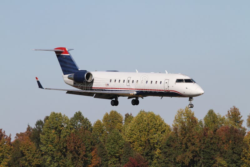 Commercial Jet Landing Above Trees Stock Photo - Image of travel, blue ...
