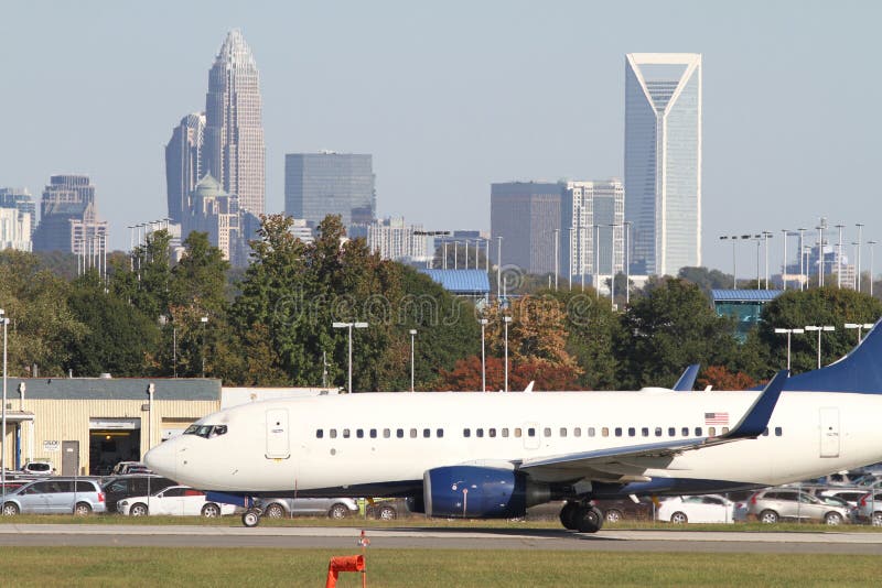 Commercial Jet on Runway with City Skyline Stock Image - Image of ...