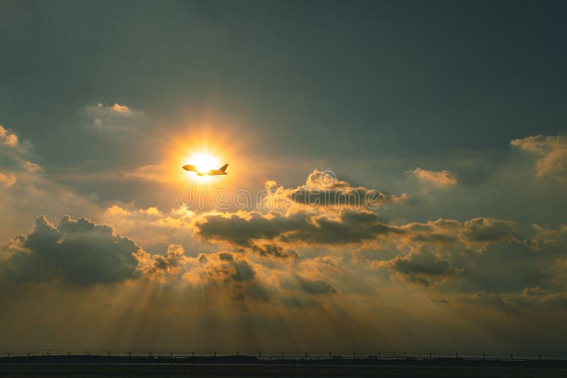 Commercial Plane Flying Over Sky Against Beautiful Sun Ray through ...