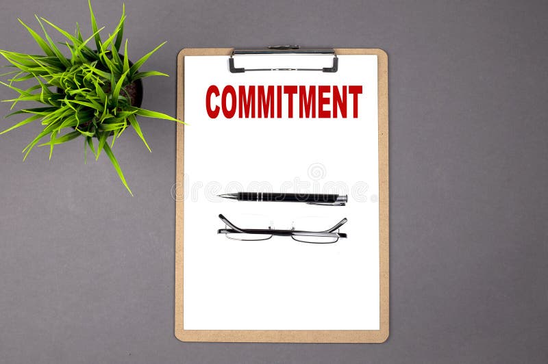 COMMITMENT on the Brown Clipboard on the Grey Background. Business ...