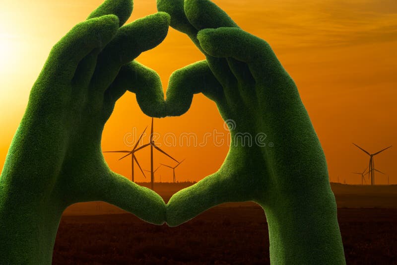 Commitment To Green Energy. a Wind Farm through the Hands Folded with a ...