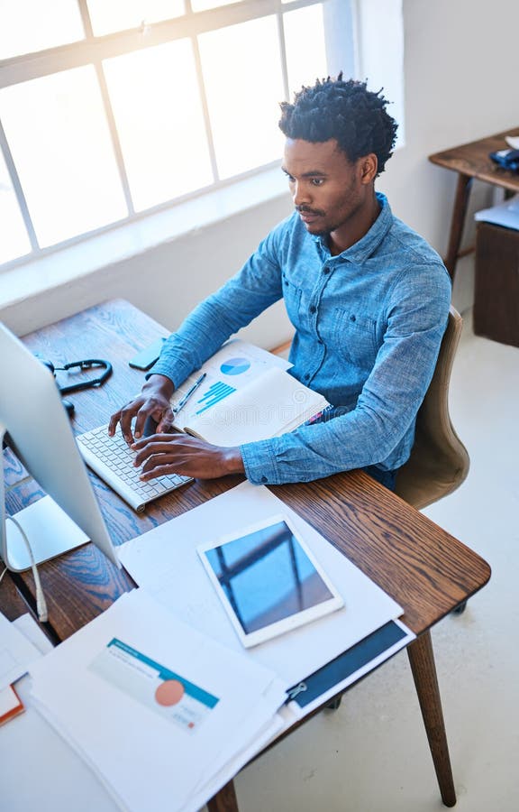 Committed To Completed His Work Tasks. a Young Man Using a Computer at ...