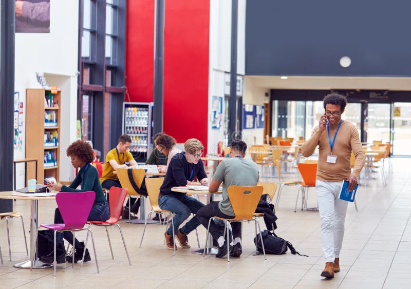 Communal Area of Busy College Campus with Students Working at Tables ...