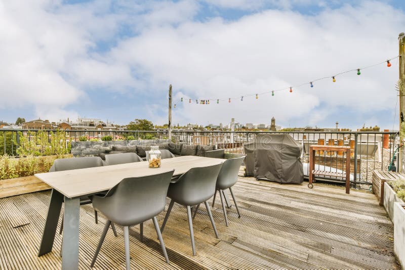 A Communal Deck with a Table and Chairs on it Stock Photo - Image of ...