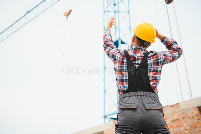 Communicating with Crane Guy. Construction Worker in Uniform and Safety ...