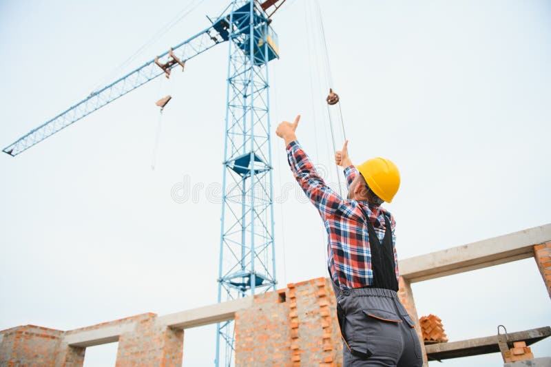 Communicating with Crane Guy. Construction Worker in Uniform and Safety ...
