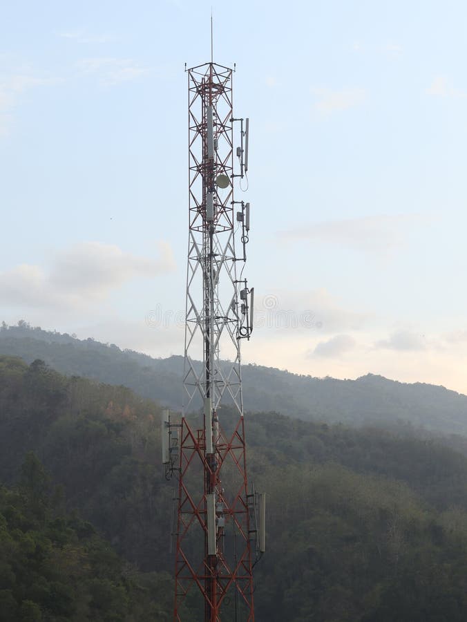 Communication Building Antenna with a Backdrop of Mountains and Sky ...