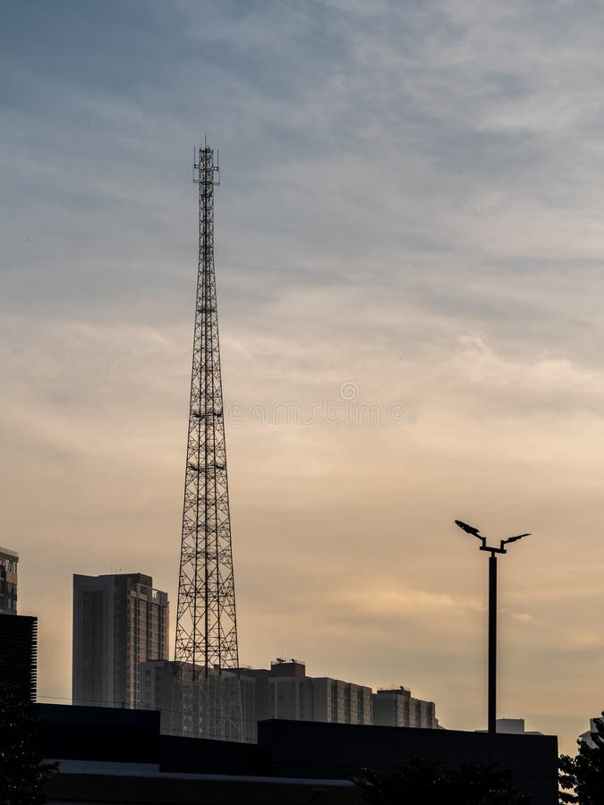 The Communication Pole, Street Light Lamp, and the High-rise Building ...