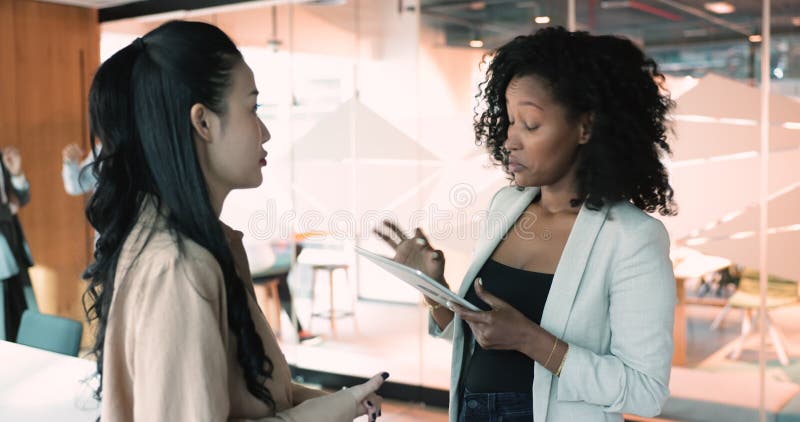 Workmates Standing in Workspace Lead Conversation, Share Solution and ...