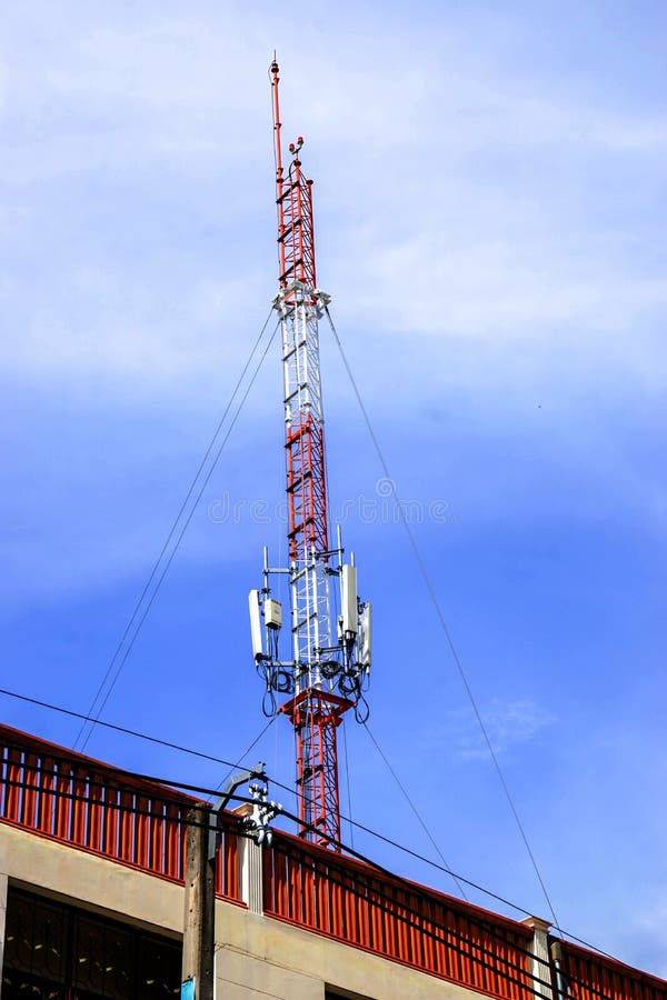 Communication Tower with Antennas on the Top of Building and Bright ...