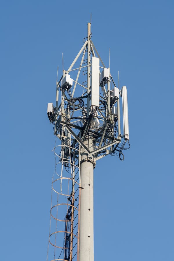 Communication Transmitters on a Concrete Pole Against the Blue Sky ...