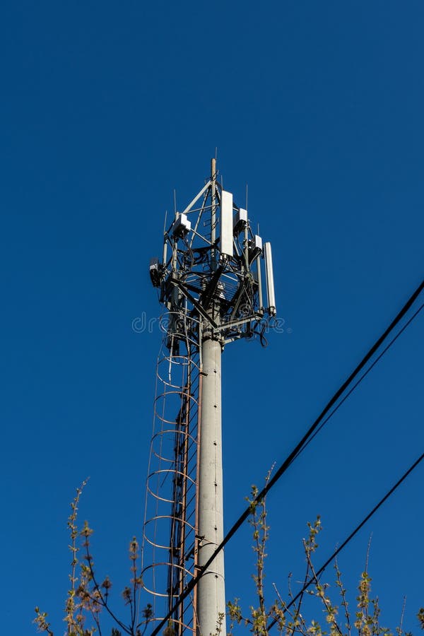 Communication Transmitters on a Concrete Pole Against the Blue Sky ...