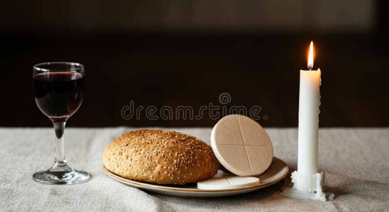 Communion Setup with Bread, Wine, and Candle on Table. Symbolizing ...