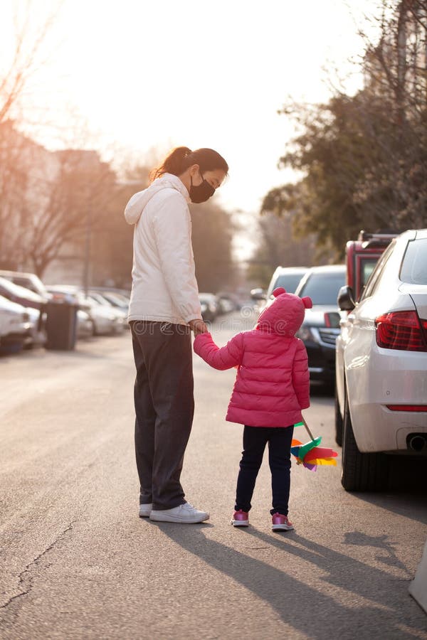 In the Community, the Mother Holding the Child Back Stock Photo - Image ...