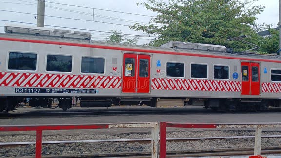 Commuter Train with a Distinctive Red and White Livery Featuring Zigzag ...