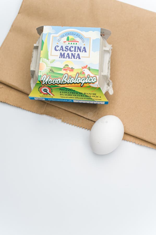 Cardboard Egg Box and White Fresh Eggs on a White Tabletop Backg ...