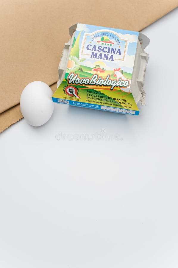 Cardboard Egg Box and White Fresh Eggs on a White Tabletop Backg ...
