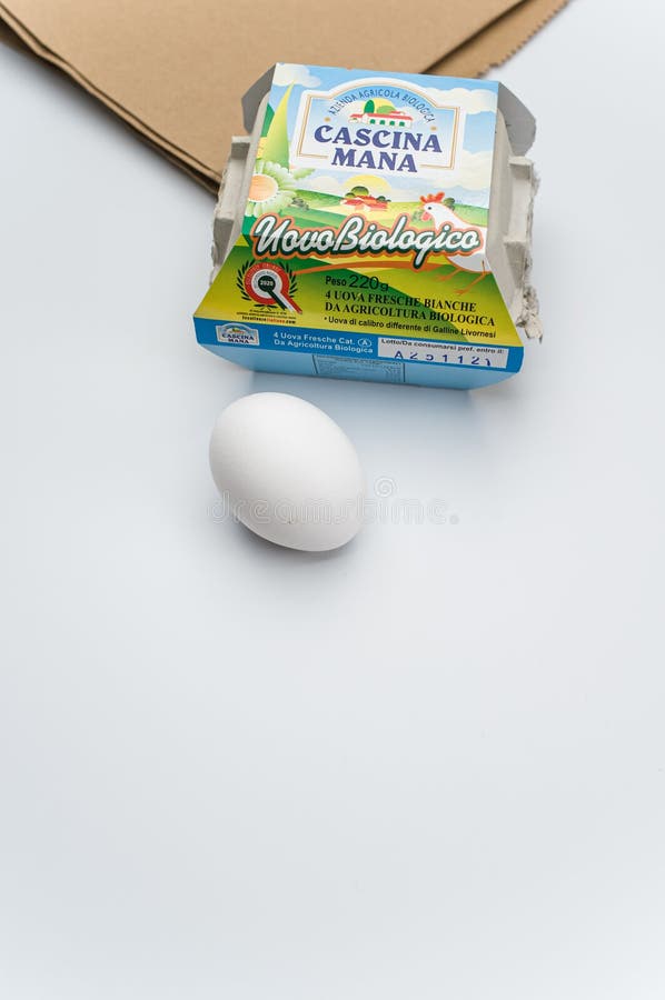 Cardboard Egg Box and White Fresh Eggs on a White Tabletop Backg ...