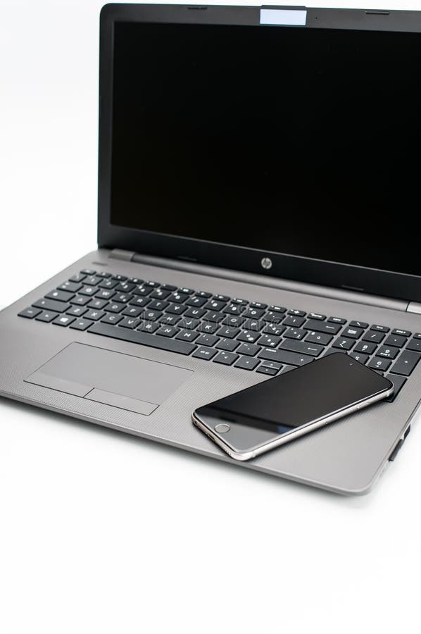 Dark Gray Laptop Computer and Smartphone on a White Tabletop Editorial ...