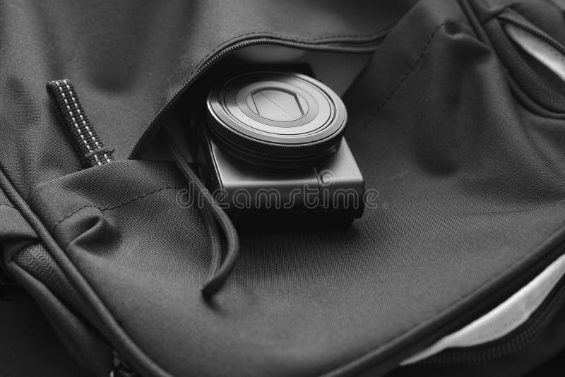 Compact Camera Inside a Backpack. Black and White Stock Photo - Image ...