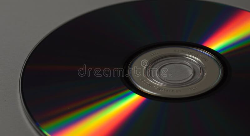 Compact Disc with a Dark Surface Reflecting Colorful Rainbow Patterns ...