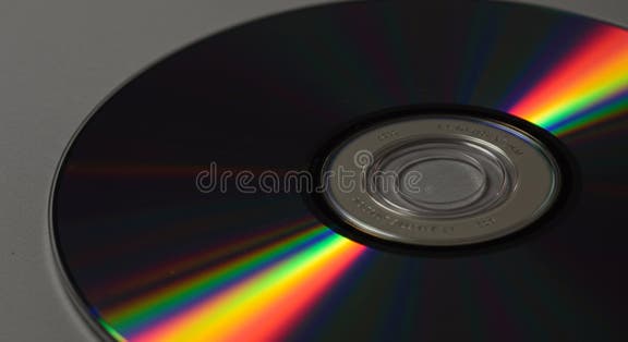 Compact Disc with a Dark Surface Reflecting Colorful Rainbow Patterns ...