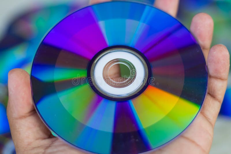 Compact Disc. Holding a CD in Hands. the Back Side of the CD Reflects ...