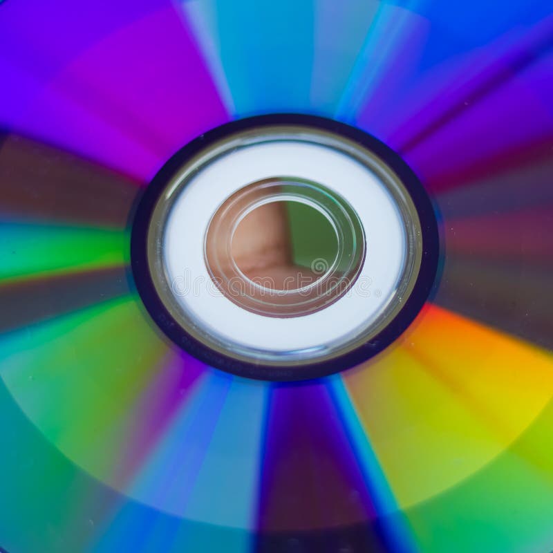 Compact Disc. Holding a CD in Hands. the Back Side of the CD Reflects ...