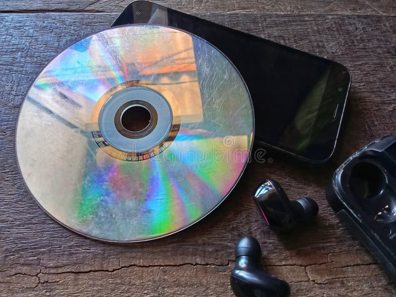 A Compact Disc and Smartphone on the Table Stock Photo - Image of ...