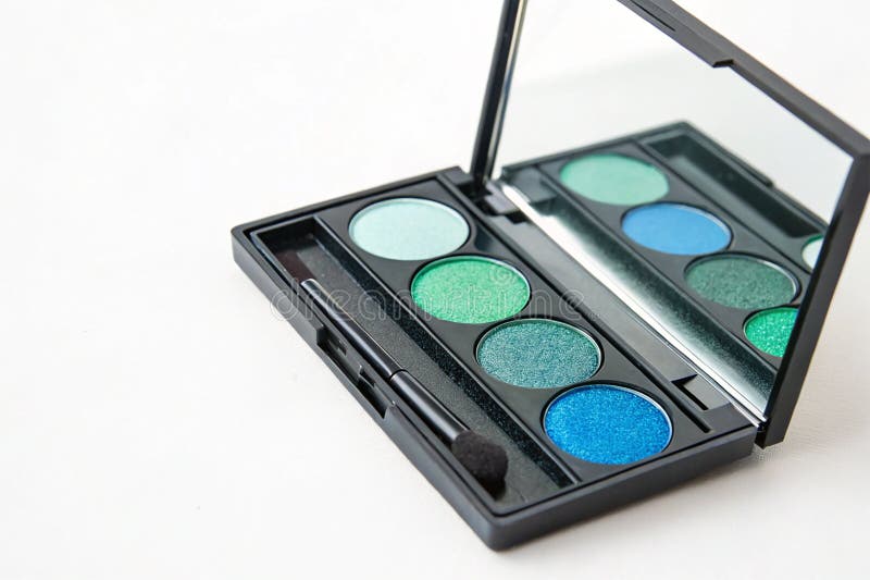 A Compact Eyeshadow Palette Featuring Shades of Blue and Green ...