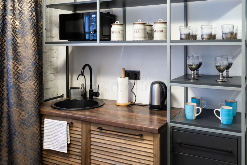Compact Kitchenette with Microwave, Sink, Kettle, and Rustic Wooden ...