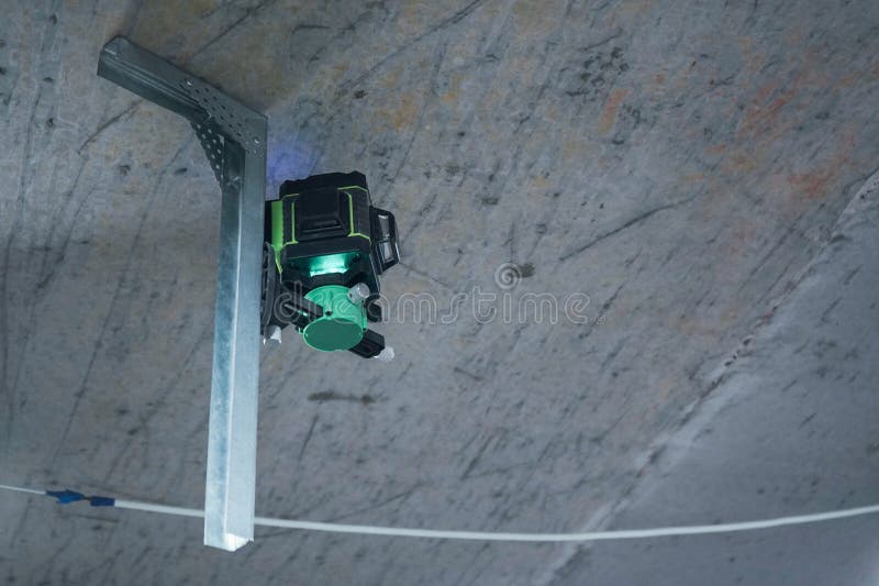 The Compact Laser Level is Securely Attached To the Ceiling of a Raw ...