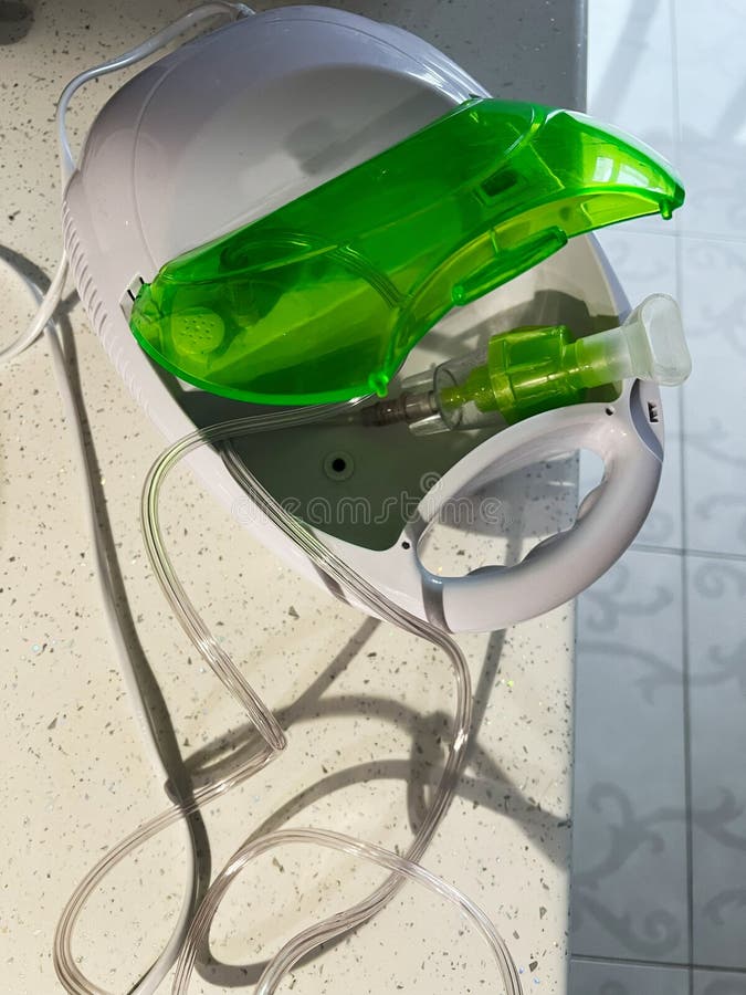 Compact Nebulizer Machine with Green Chamber on a Light Surface Stock ...