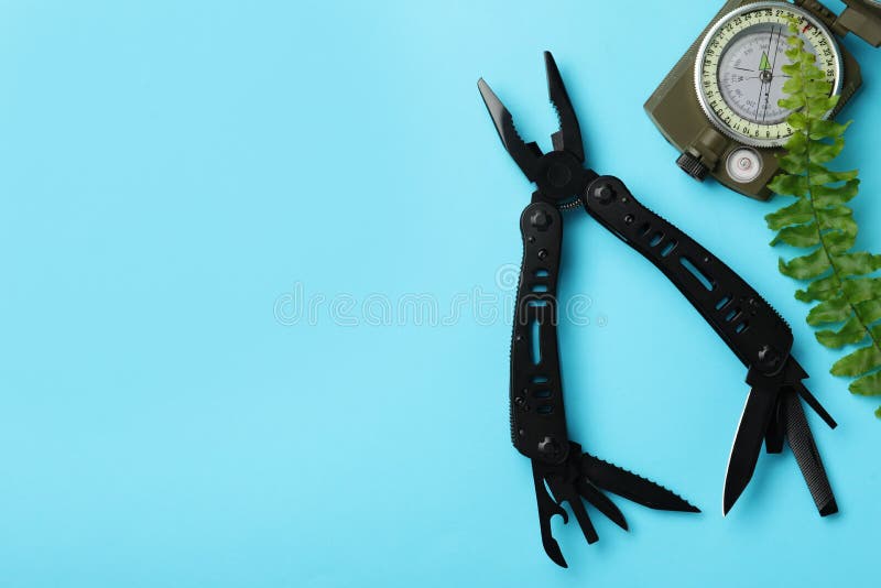 Compact Portable Multitool, Compass and Green Leaf on Light Blue ...