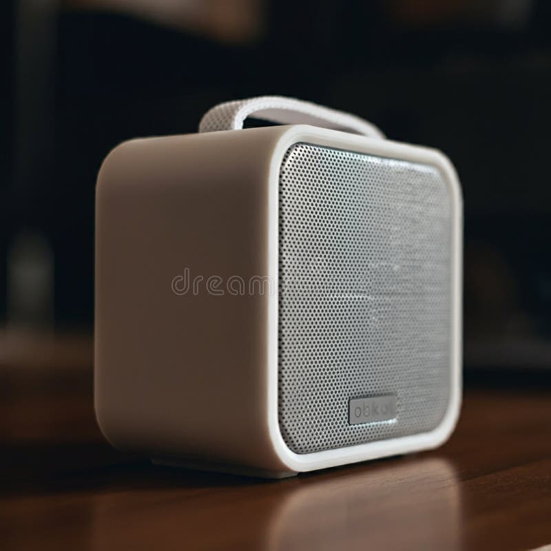 Compact Portable Speaker with a White, Rounded-rectangular Body and a ...