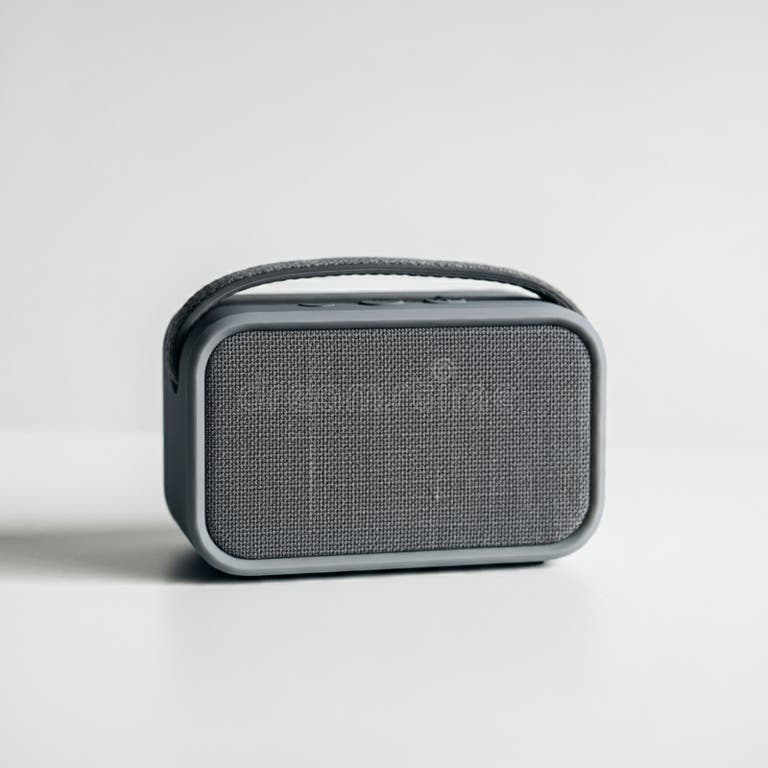 A Compact, Rectangular Bluetooth Speaker with a Soft Gray Fabric Front ...