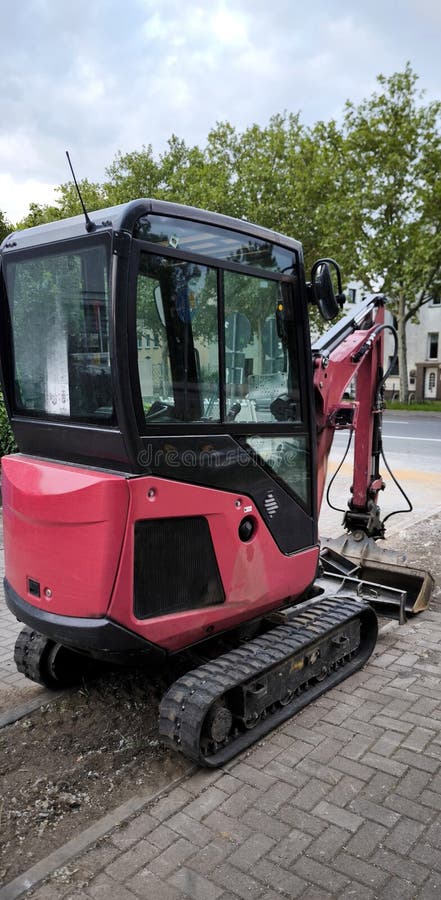 Mini Excavator Parked on the Dirt Outside a New Home Building Project ...