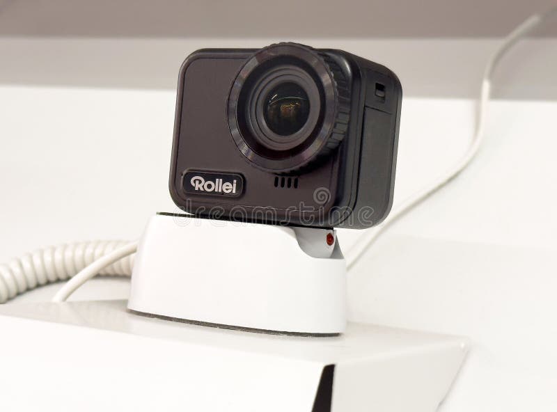Compact Rollei Action Camera on Charging Stand with Coiled Cable ...