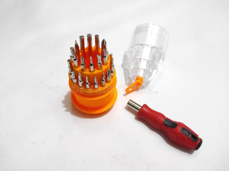 A Compact Screwdriver Set Includes a Red and Black Handle and a ...