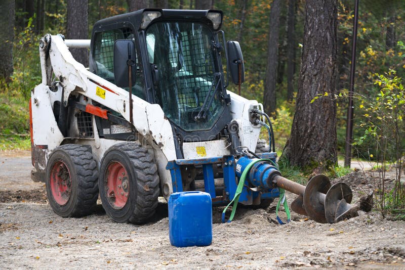 Compact Tractor with Drilling Rig in the Forest. Stock Photo - Image of ...