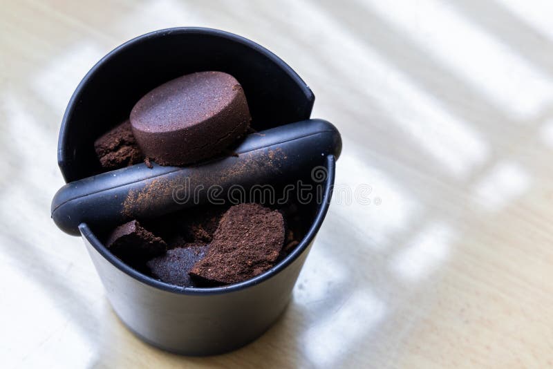 Compacted Coffee Ground in Knock Box on Table. Coffee Grounds are ...