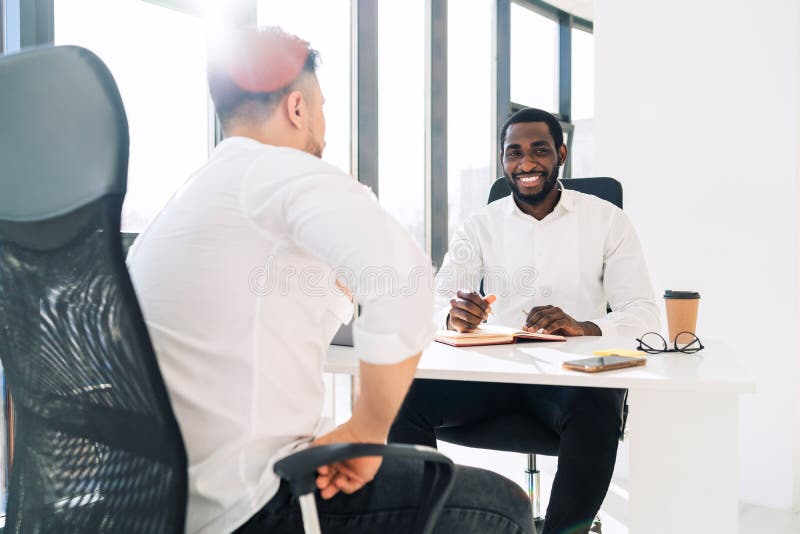Company Manager Conducts Interview for a Man. Two Mulracial Office ...