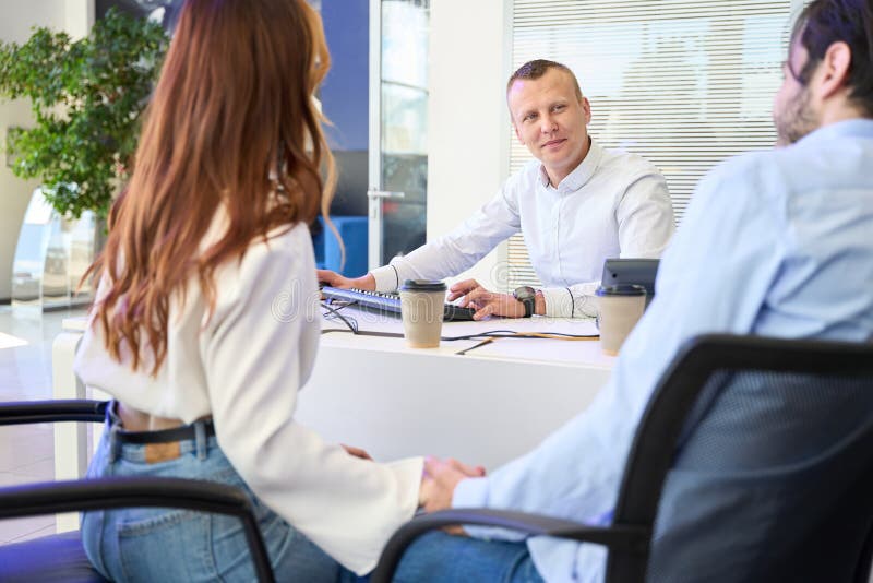 Company Representative Seated at Desk Communicating with Clients Stock ...