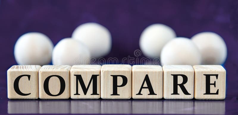 COMPARE - Word on Wooden Cubes on a Blue Background with Wooden Balls ...
