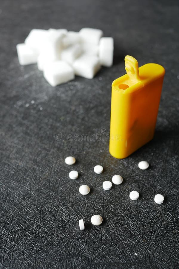 Comparing Artificial Sweetener and Sugar Cube Container on Black Stock ...