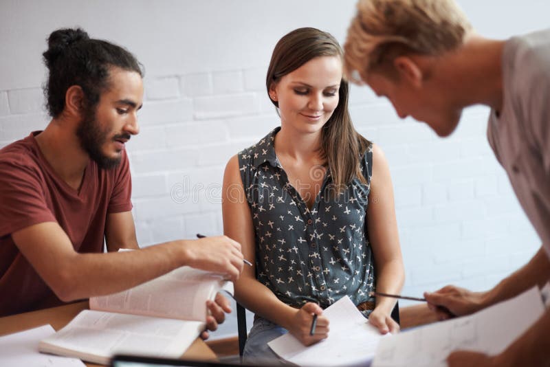Comparing Class Notes. a Group of University Students Studying Together ...
